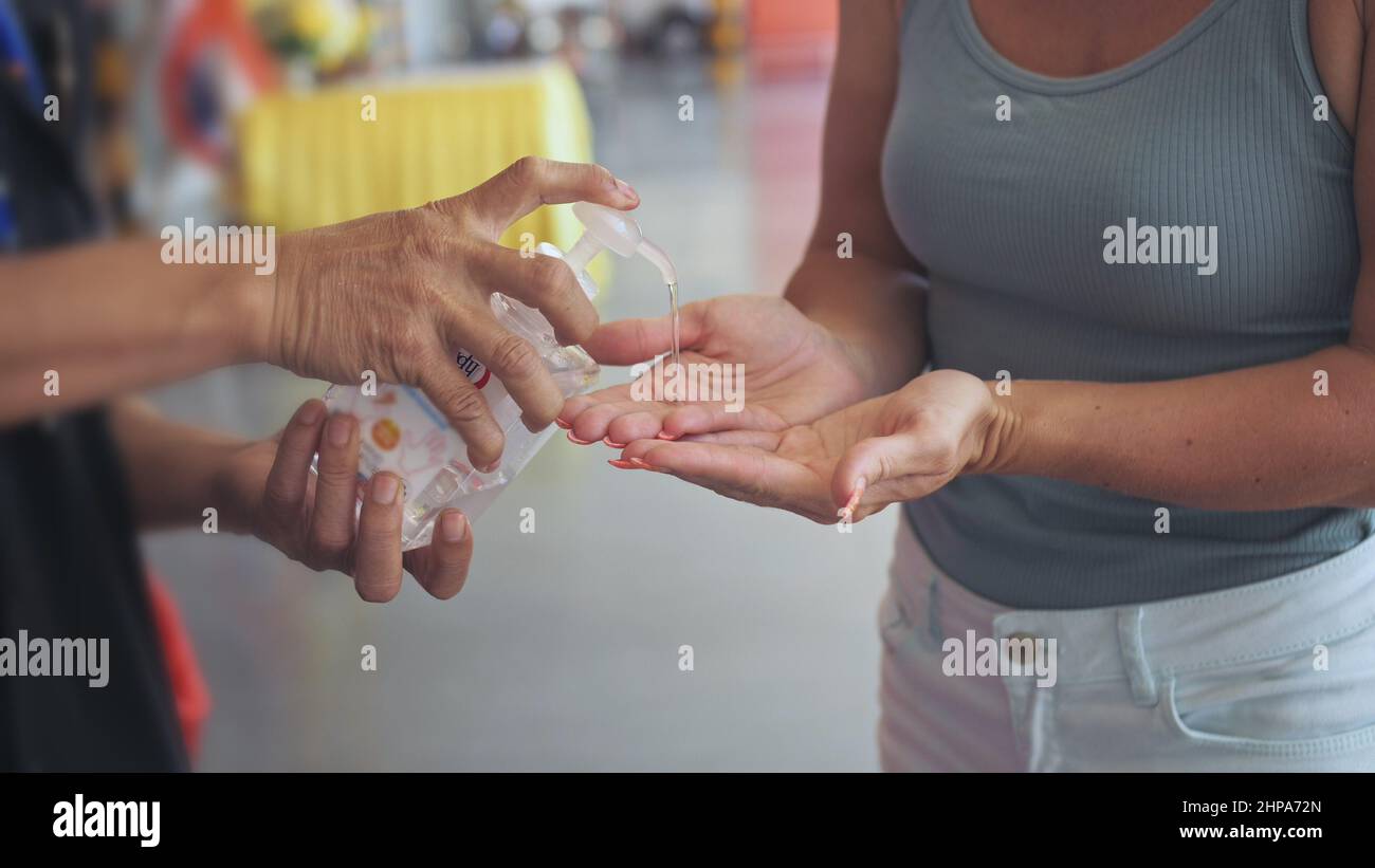 Hand Sanitizer gel. Hand treatment with alcohol. Temperature check at ...