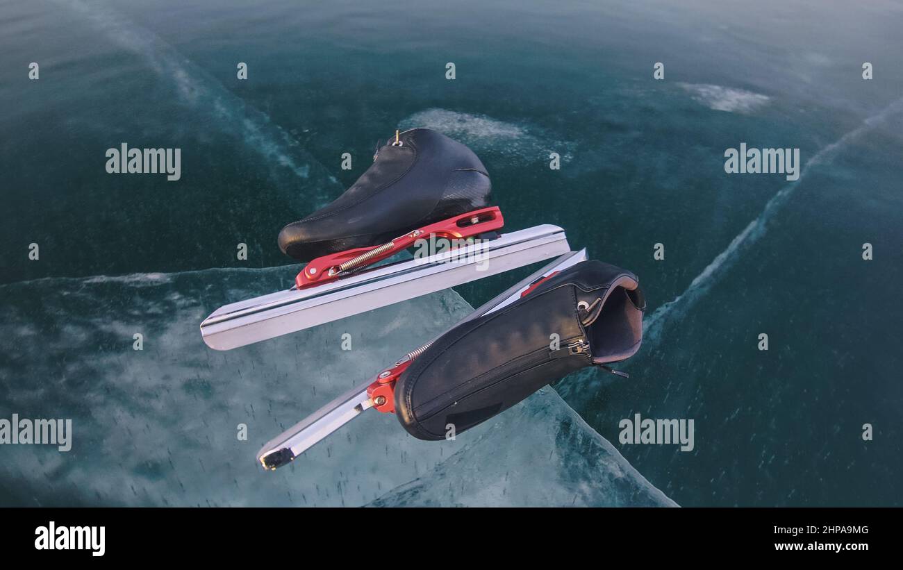 The skates boots are on the ice. The child train on ice speed skating ...
