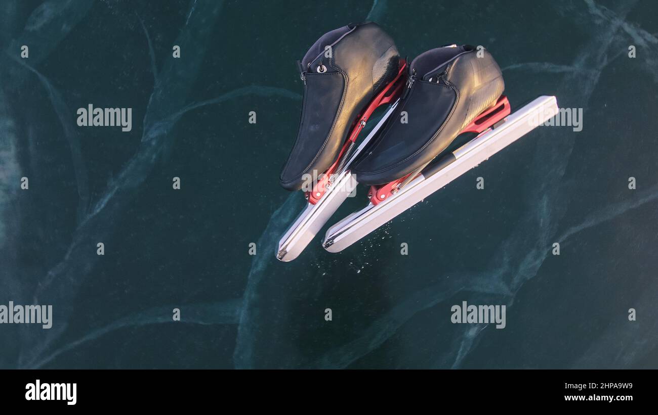The skates boots are on the ice. The child train on ice speed skating ...