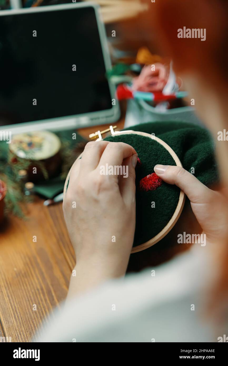 Woman sewing on green cloth Stock Photo - Alamy