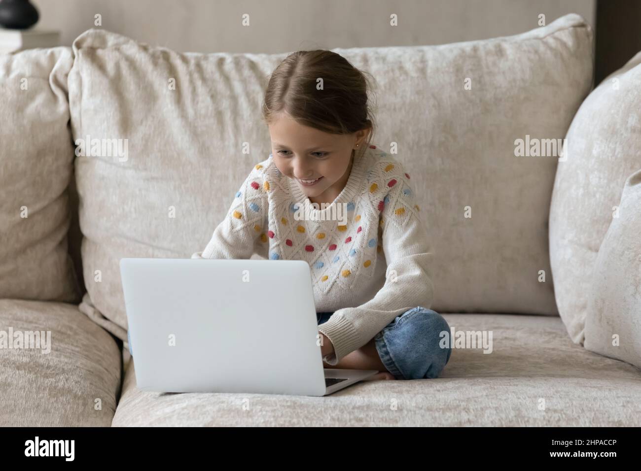 Happy kid using online learning app on laptop computer Stock Photo - Alamy