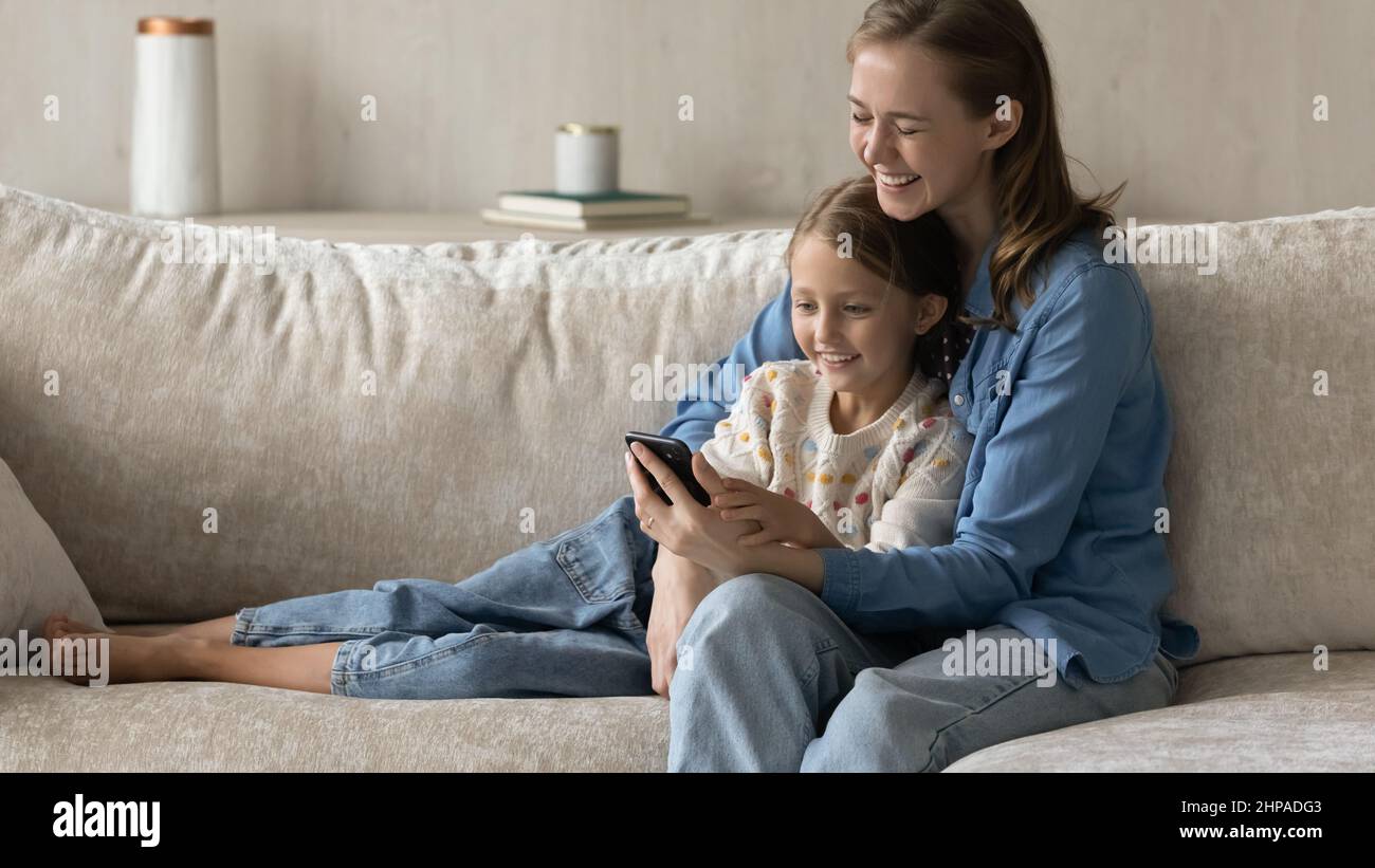 Happy mom and kid using online ecommerce app on smartphone Stock Photo ...