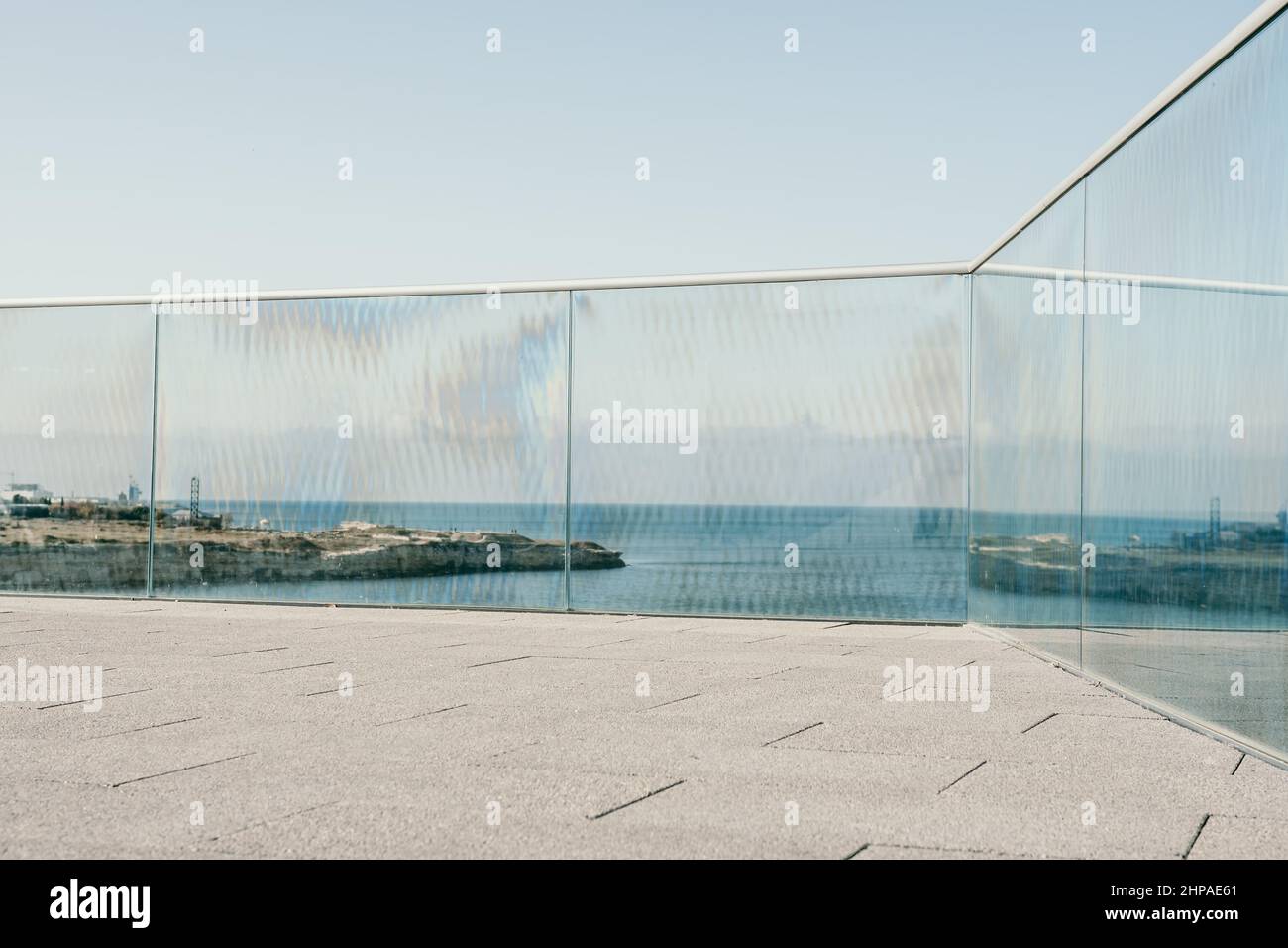 Glass fence in the seaside park. a popular viewpoint, admiring the ...