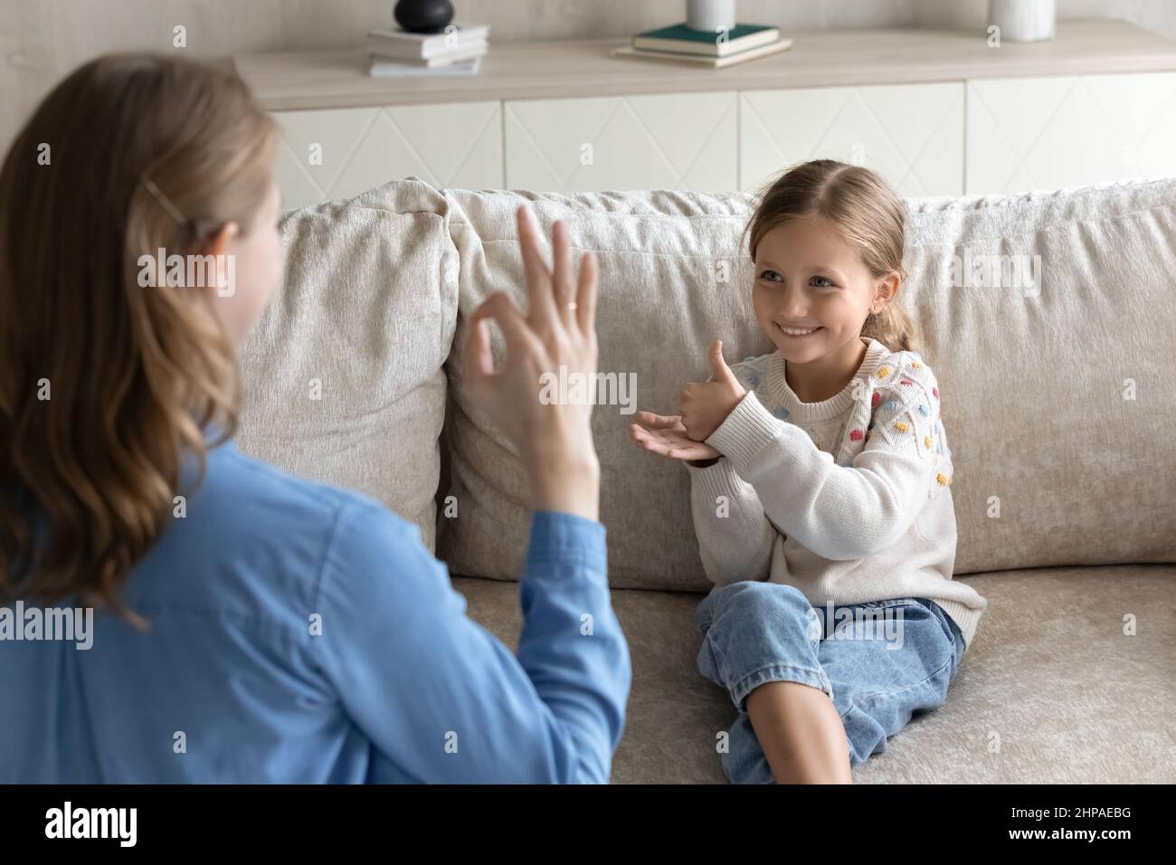 Happy little kid and mom speaking sign language Stock Photo - Alamy