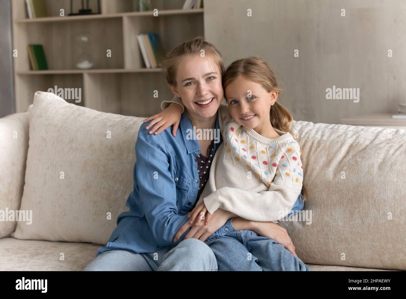 Happy young pretty mother embracing sweet daughter kid with love Stock ...
