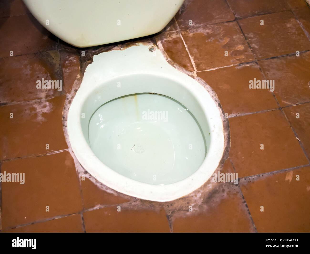 A toilet bowl built into the floor in a toilet of the USSR era Stock ...