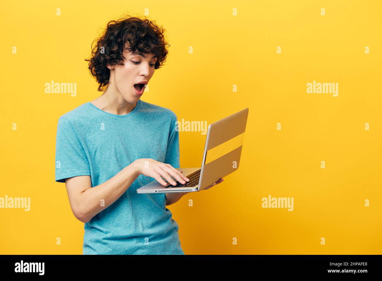 guy laptop online chat communication yellow background Stock Photo - Alamy