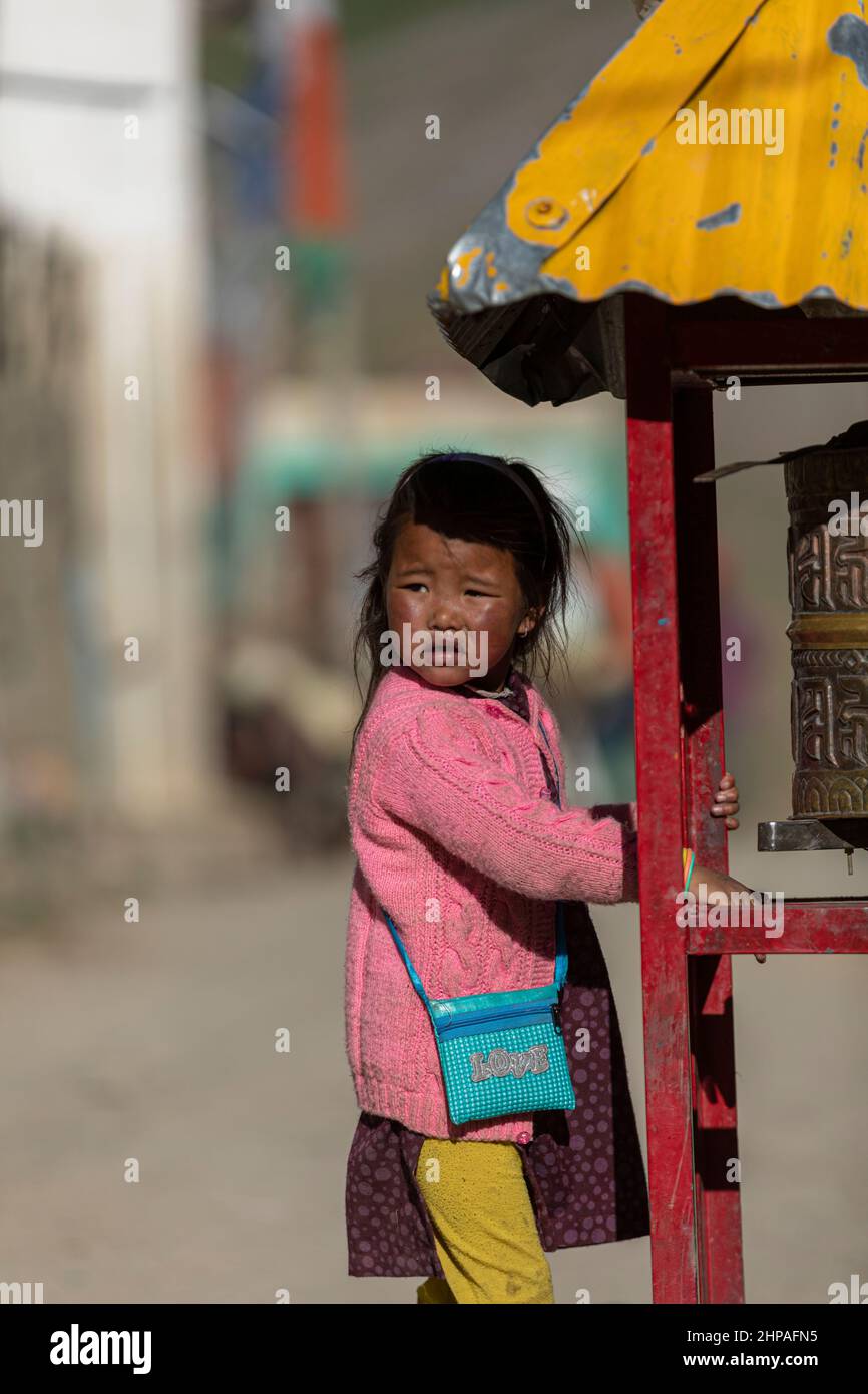 young gird near praying wheel,Spiti Valley, Himachal Pradesh, India ...