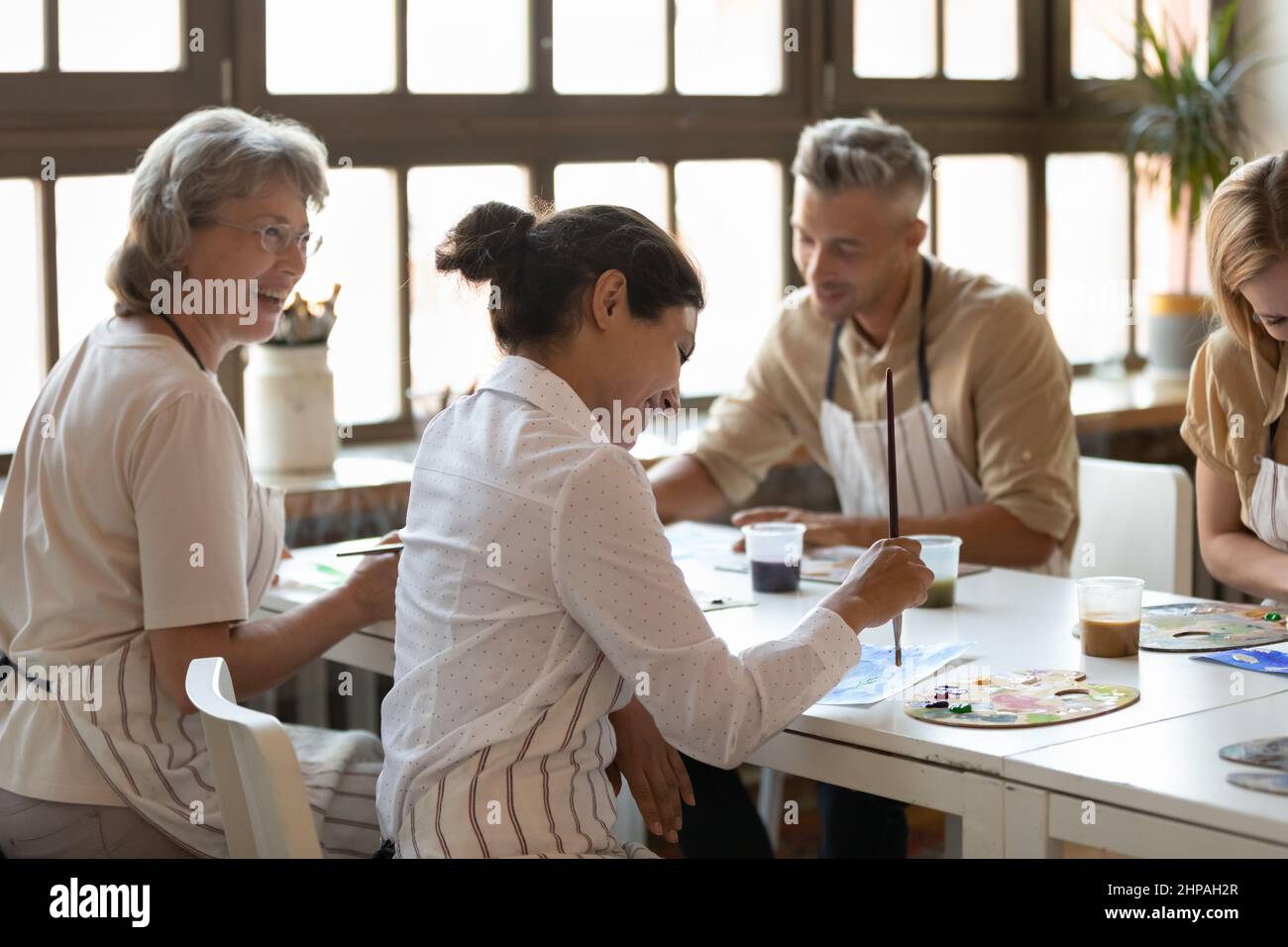 Happy diverse different ages people drawing picture at art class Stock ...