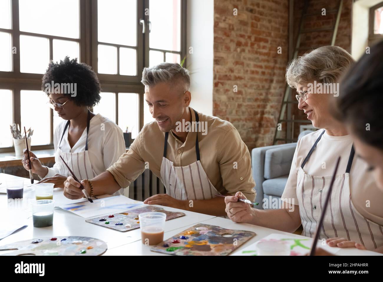 Happy handsome man enjoying drawing workshop with diverse people Stock ...