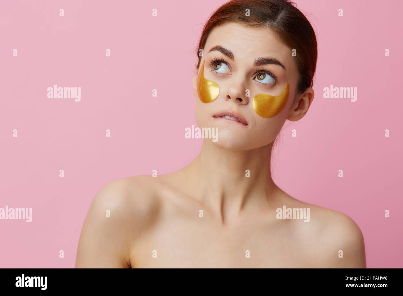 portrait woman golden patches on the face pink background Stock Photo ...