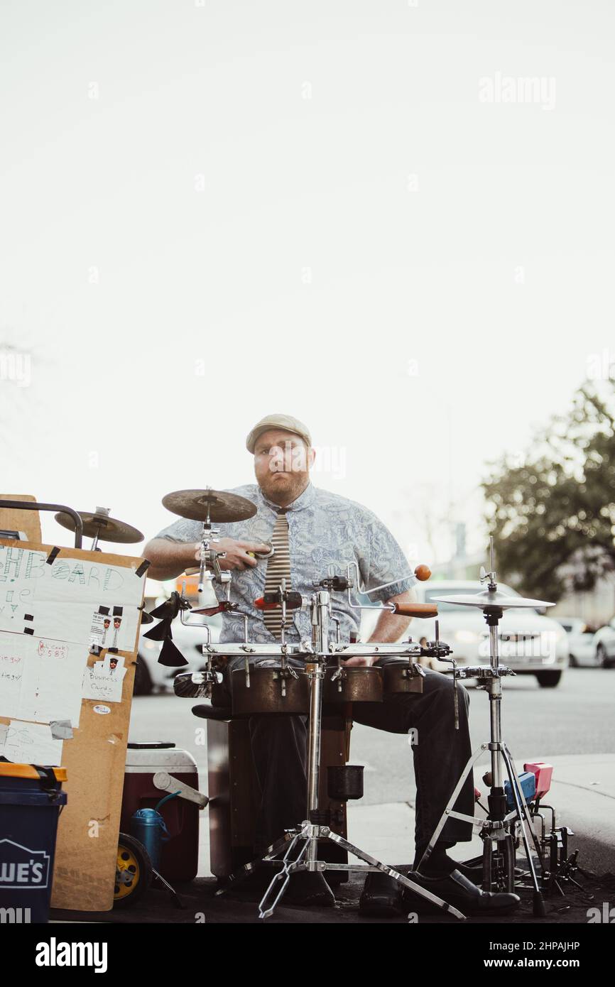 Vertical shot of a unique street performer playing drums Stock Photo ...