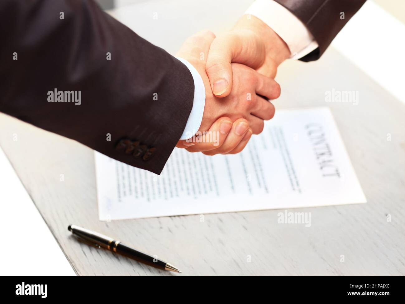 the conclusion of the contact. Closeup of a business hand shake between ...