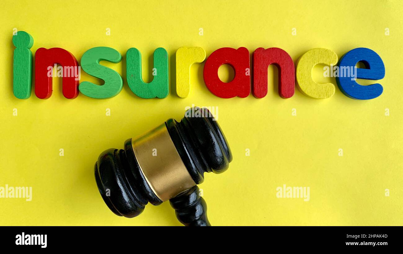 Top view of word Insurance and gavel with yellow paper background Stock ...