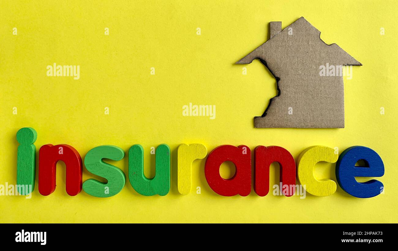 Top view of text and burnt model paper house - Insurance with yellow ...