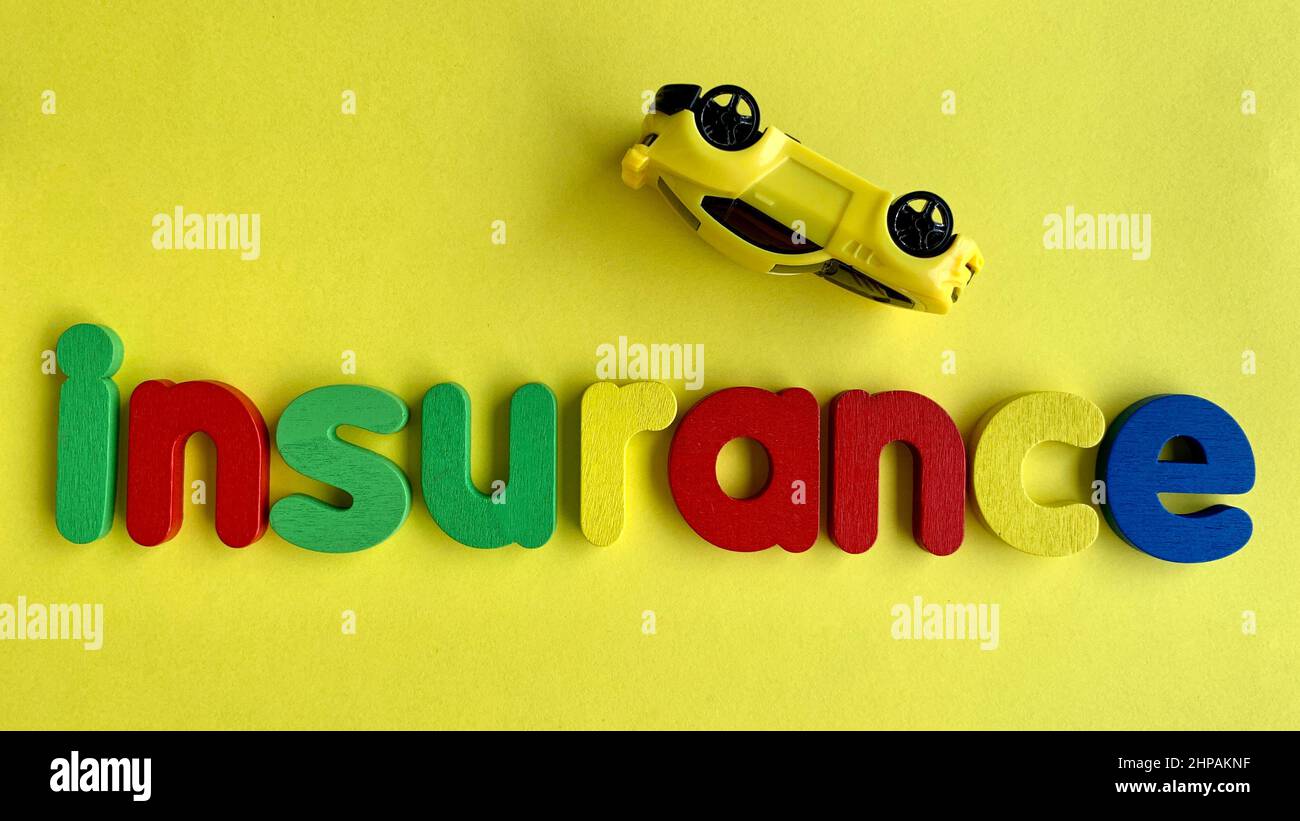 Top view of text - Insurance with car model and yellow background Stock ...