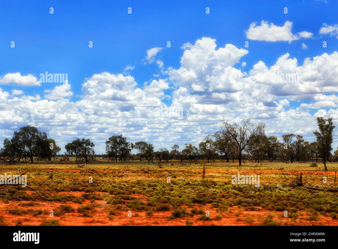 Side view of red soil outback road side from high-speed moving car ...
