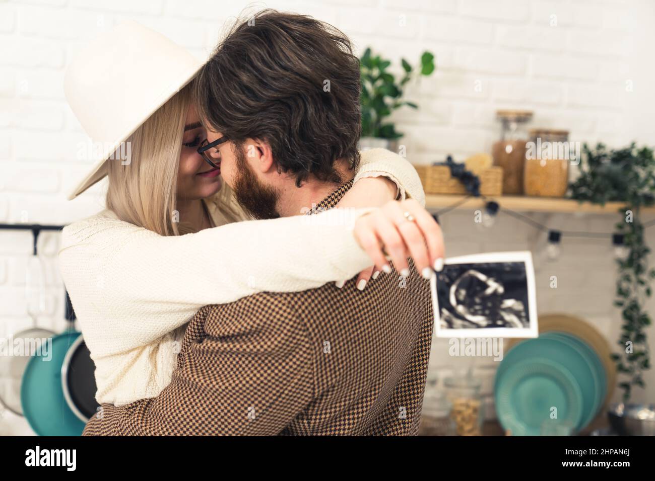 Cheerful Millennial Caucasian Wife Hugging Her Husband And Holding