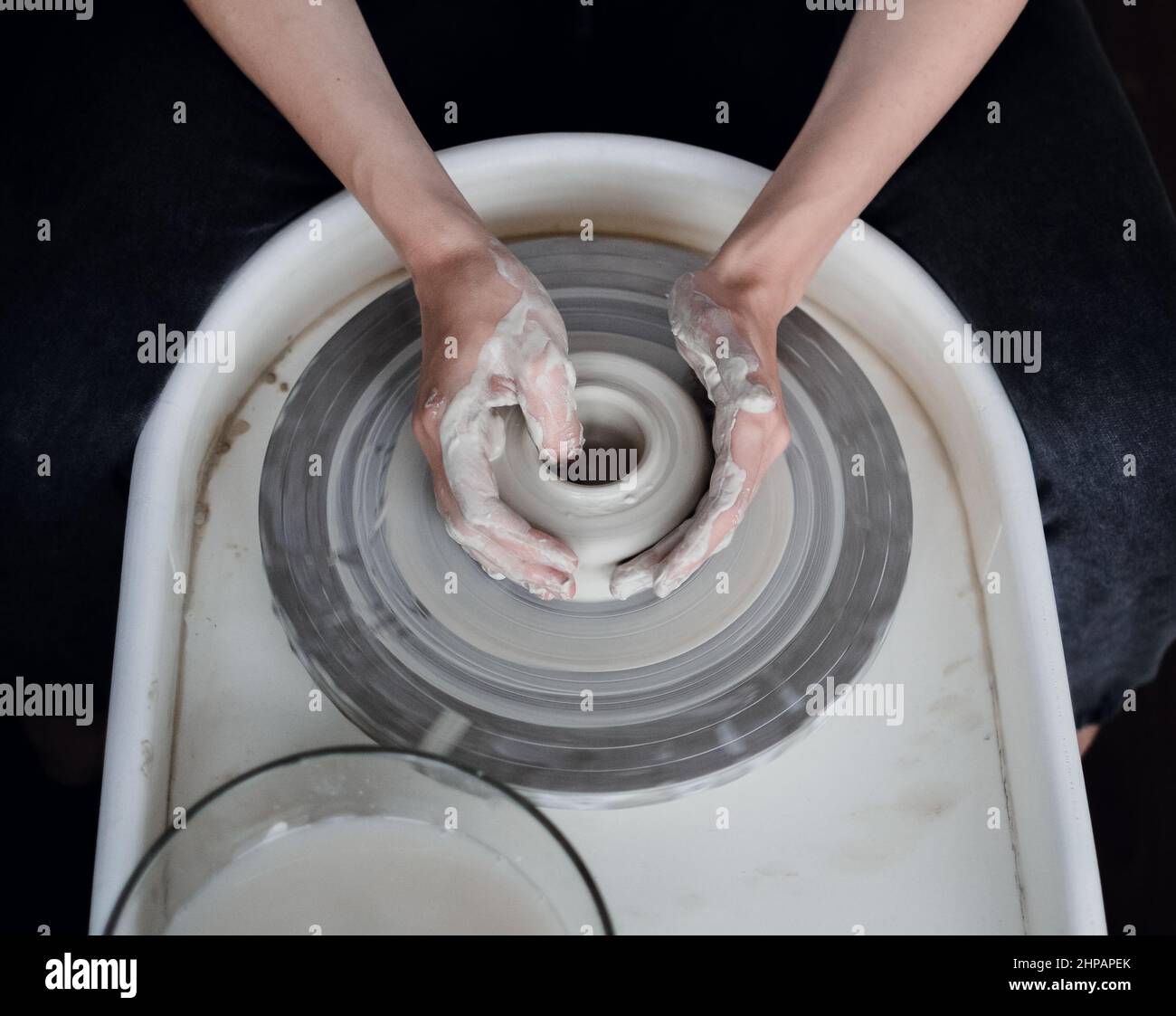 Hands on the potter's wheel top view Stock Photo - Alamy