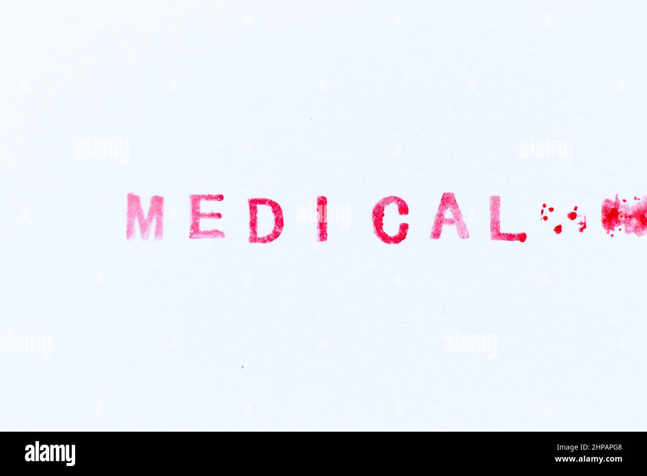 Red color ink rubber stamp in word medical on white paper background ...