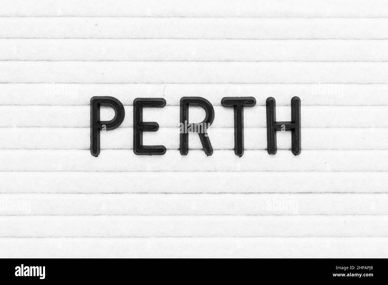 Black color letter in word perth on white felt board background Stock ...