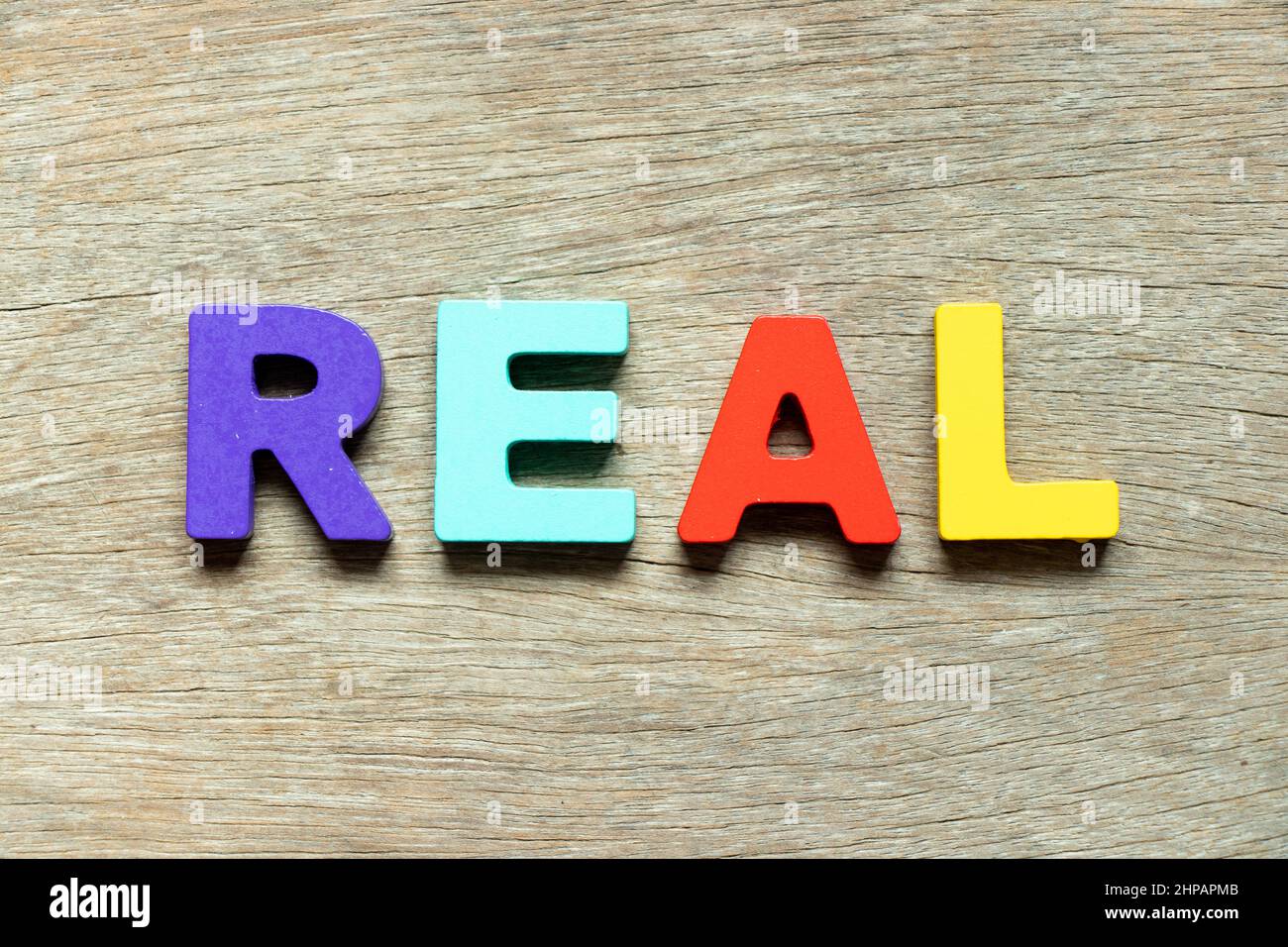 Color alphabet letter in word real on wood background Stock Photo - Alamy