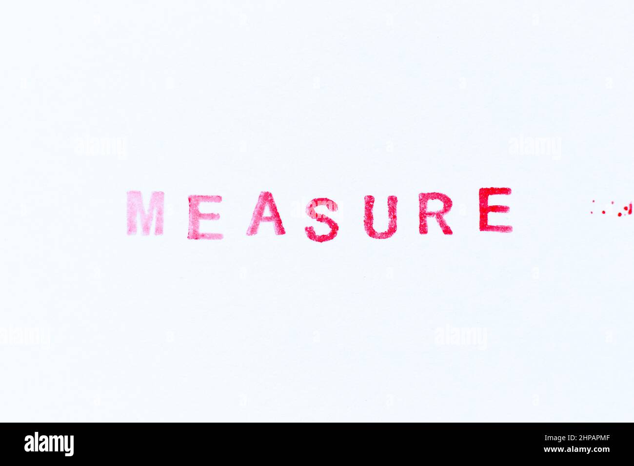 Red color ink rubber stamp in word measure on white paper background ...