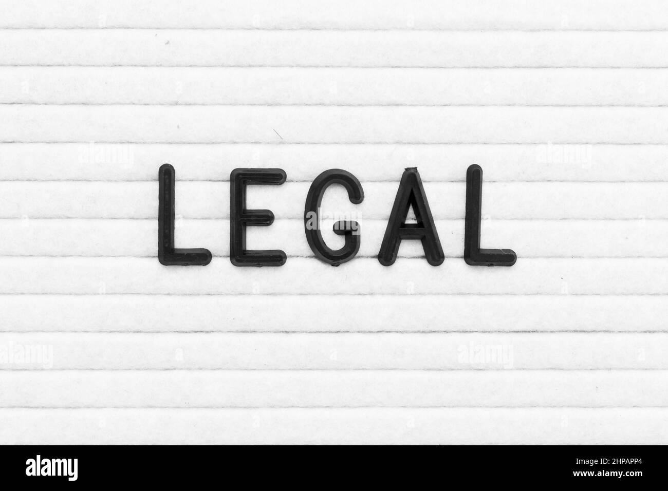 Black color letter in word legal on white felt board background Stock ...