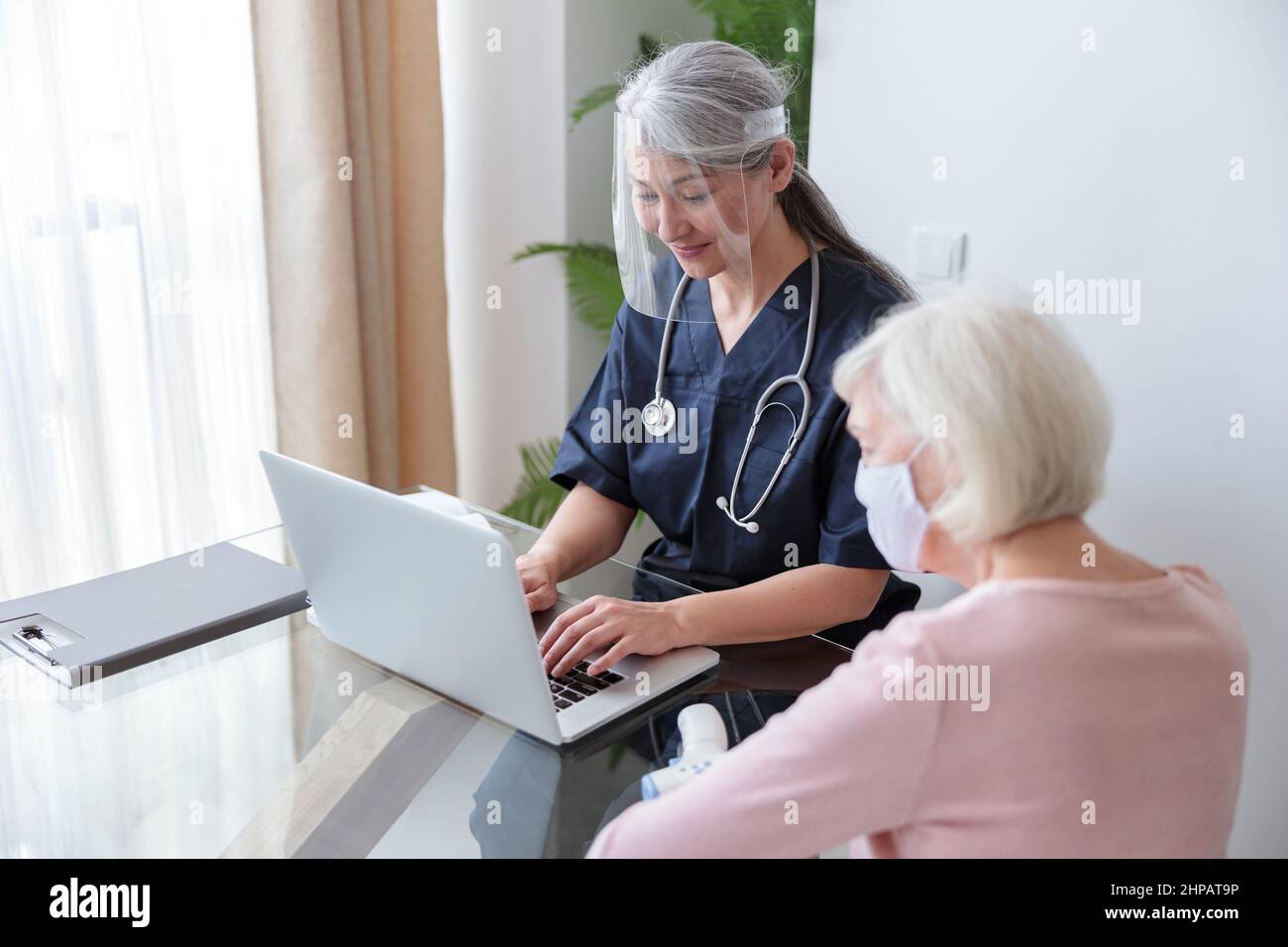 Female doctor and patient at home visit Stock Photo - Alamy