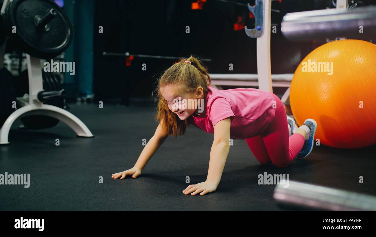 Fit Athletic Baby Girl Work out Stretching, Doing Her Fitness Exercise ...