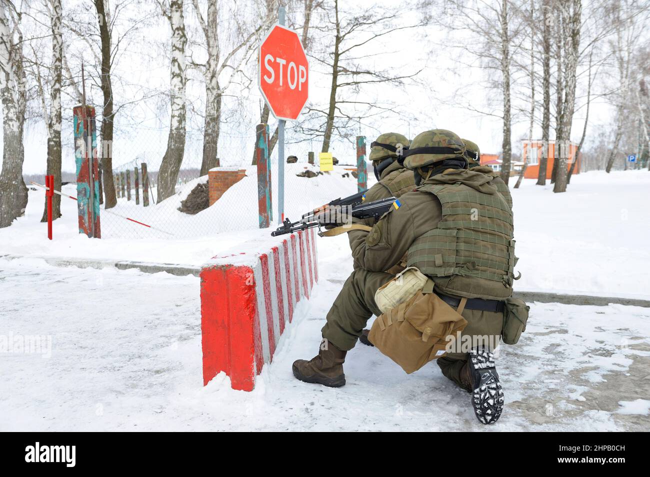 Soldiers taking position guarding roadblock. Military range, Ukraine ...