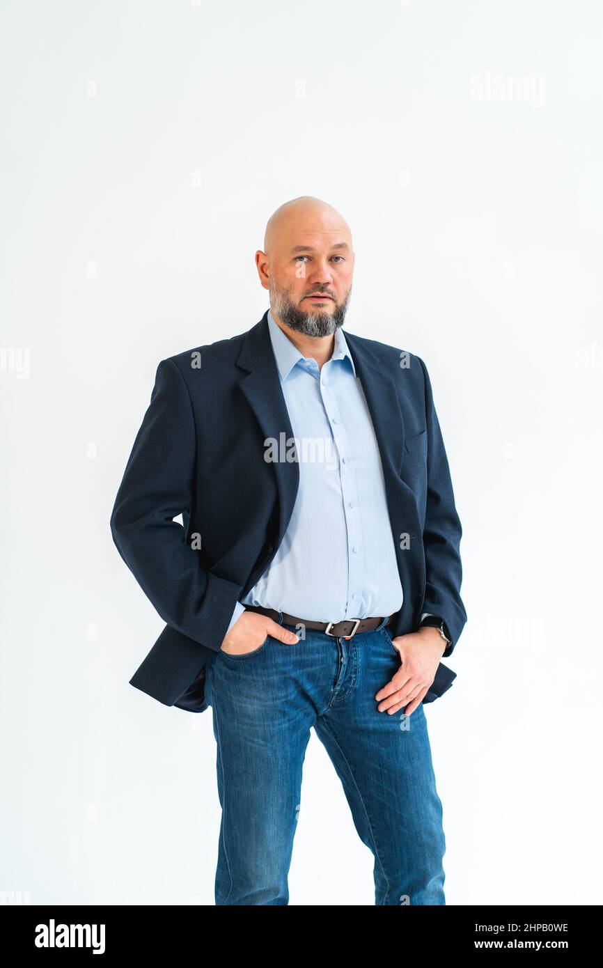 Vertical businessman bald man staying confident serious looking camera ...