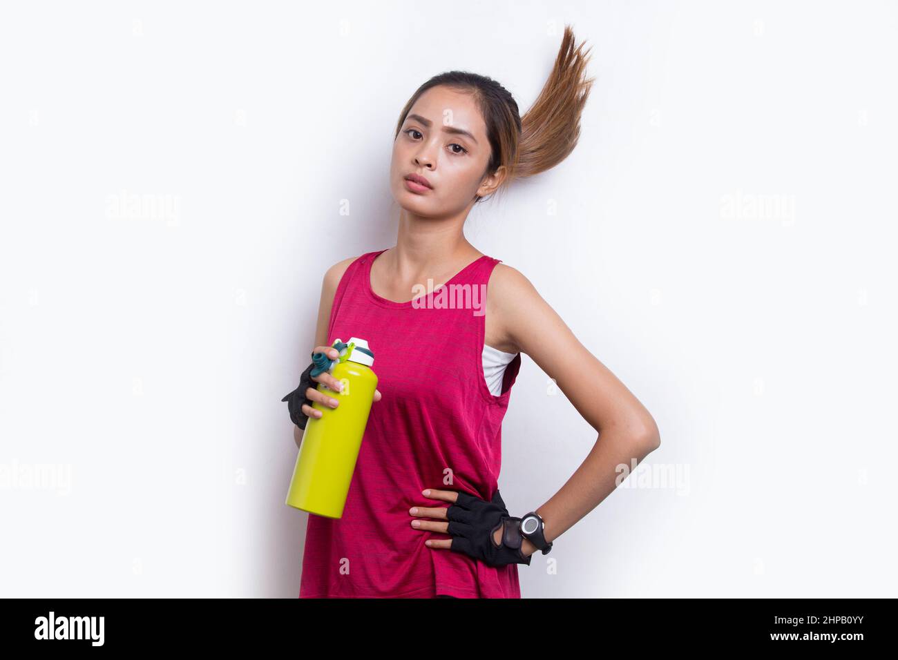 Young beautiful asian sport woman drinking water after workout on white ...