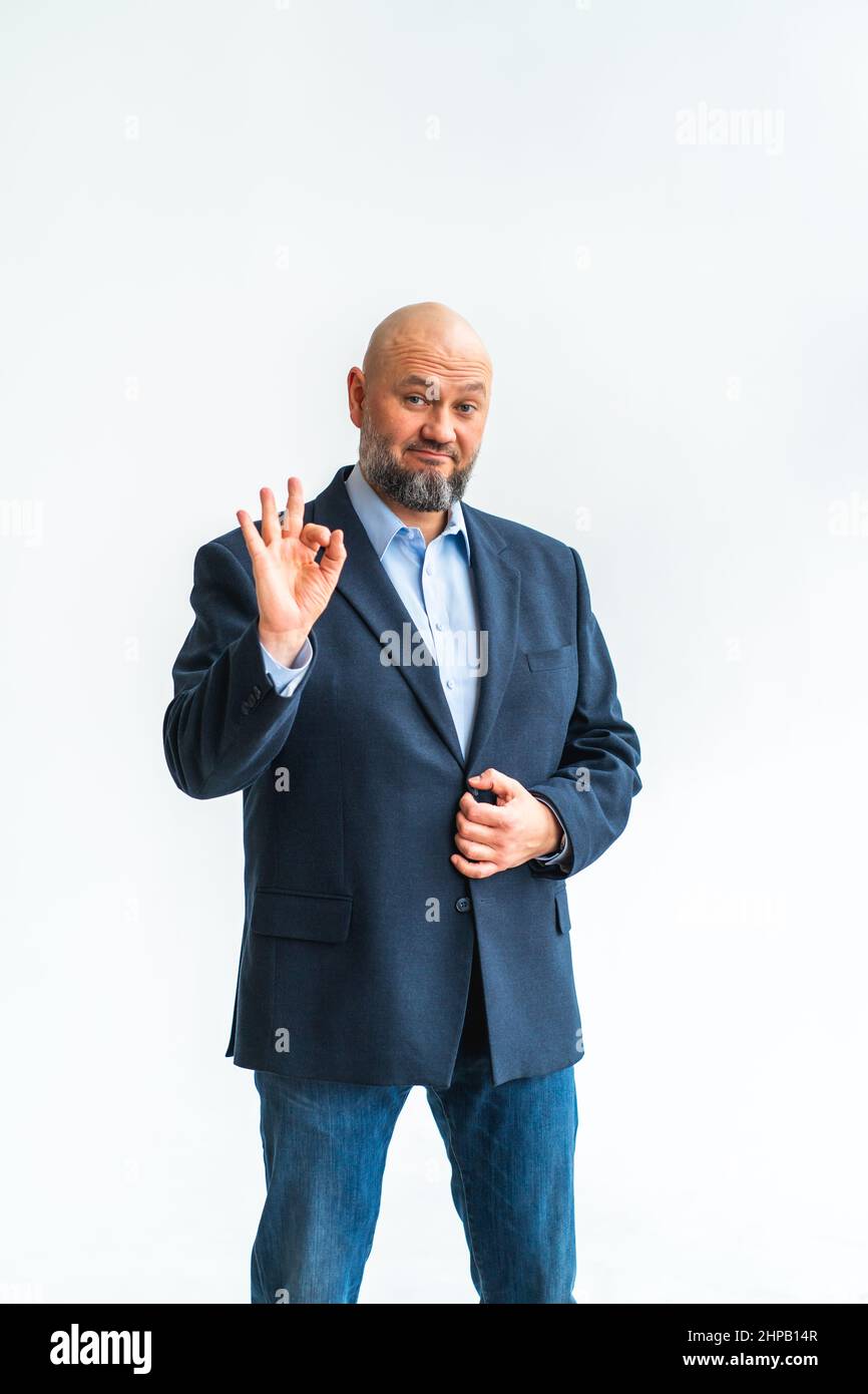 Vertical portrait confident businessman, bald man staying. Showing okay ...