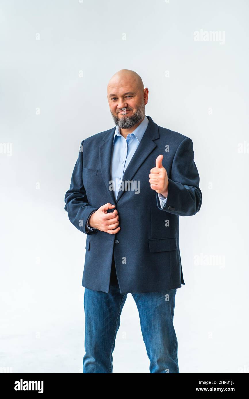 Vertical smiling confident businessman, bald man showing thumb up sign ...