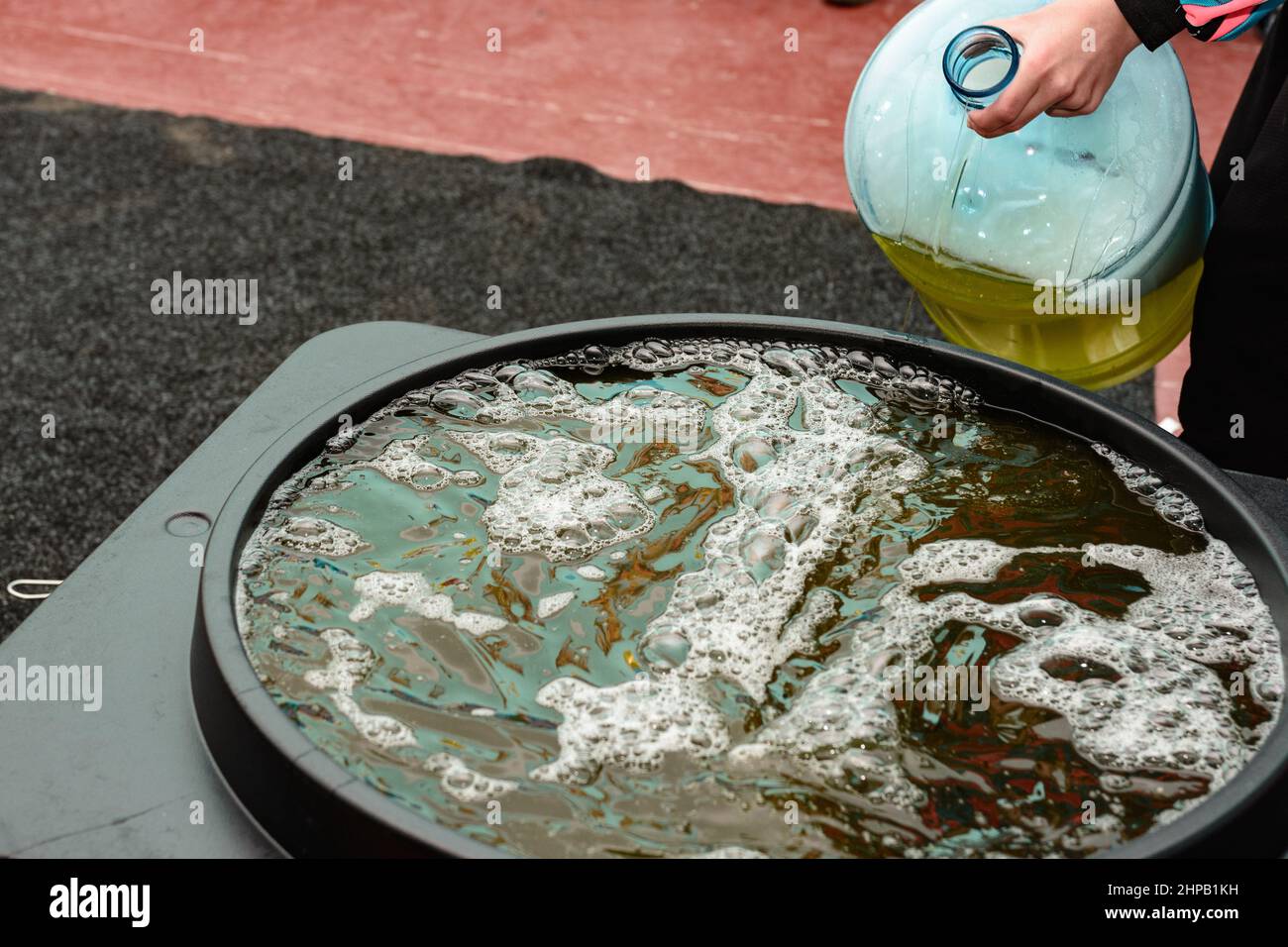 Soap solution for the holiday with soap bubbles close up, soap solution ...