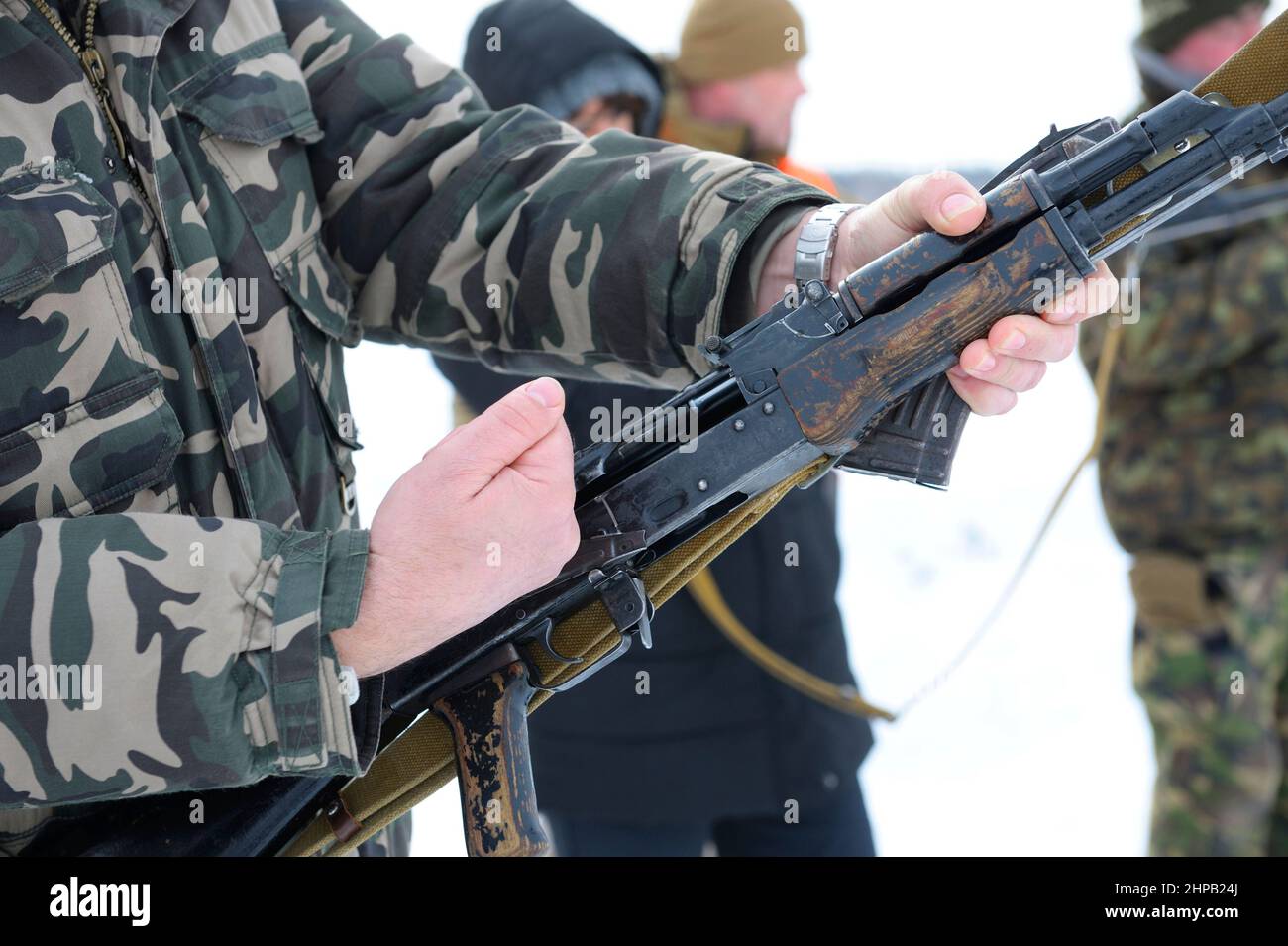 Officer instructor checking Kalashnikov rifle before training in ...