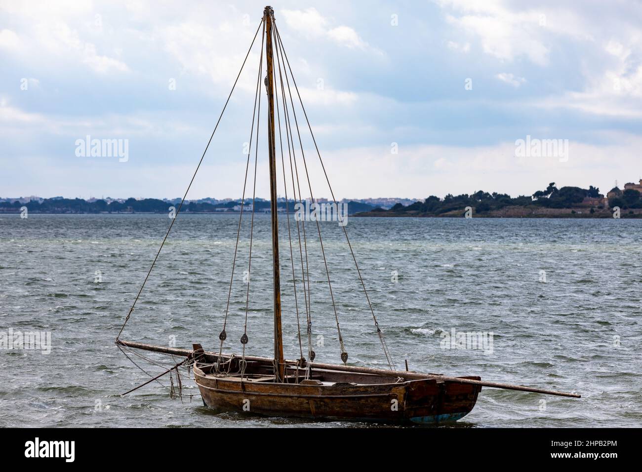 traditional mediterranean wooden sailboat anchored without sails ...