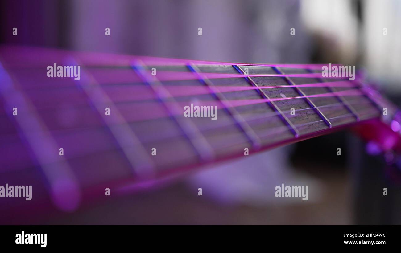 Acoustic guitar strings and fretboard on blurred background. Musical ...