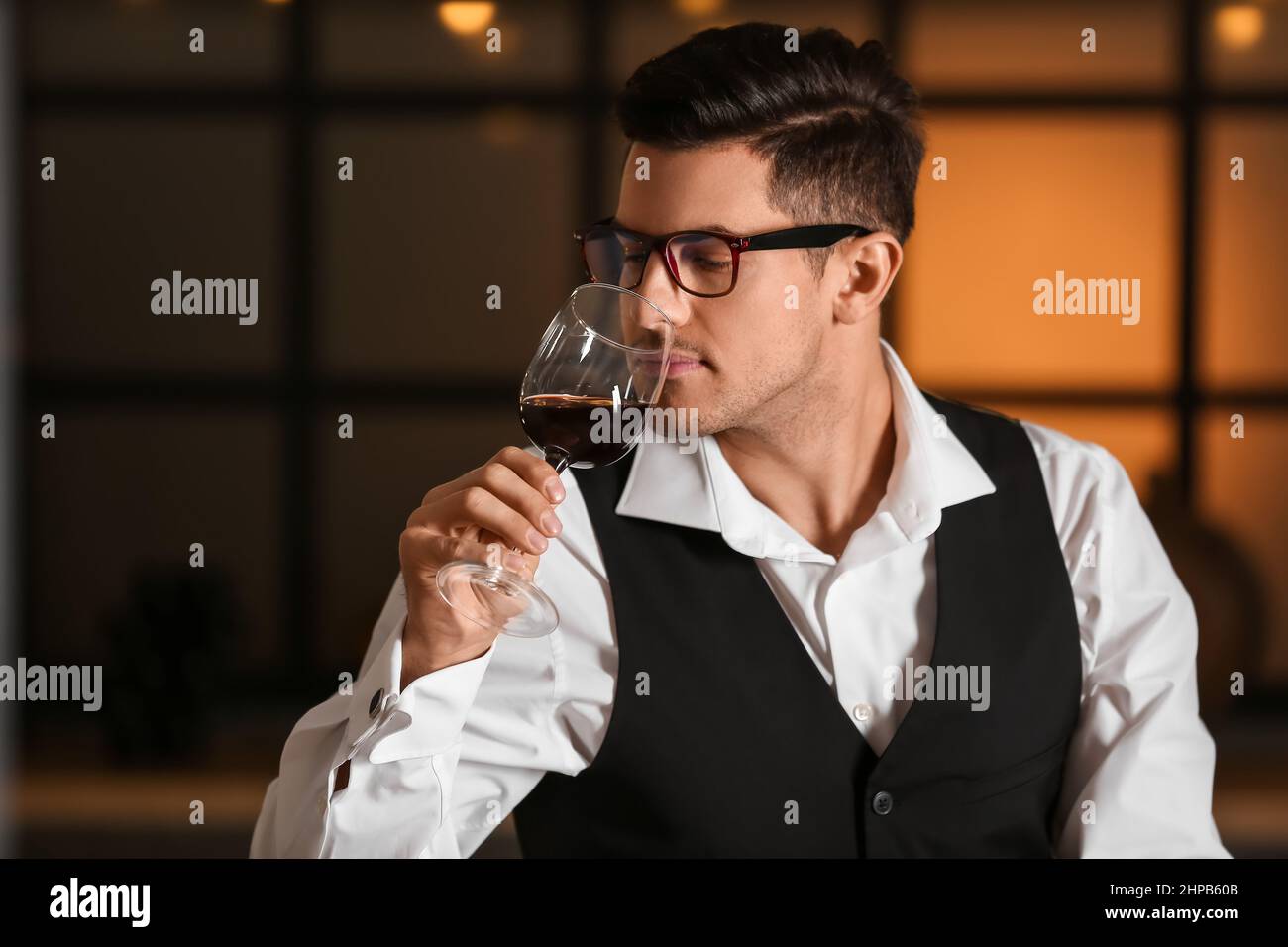 Young male sommelier tasting types of wine Stock Photo - Alamy