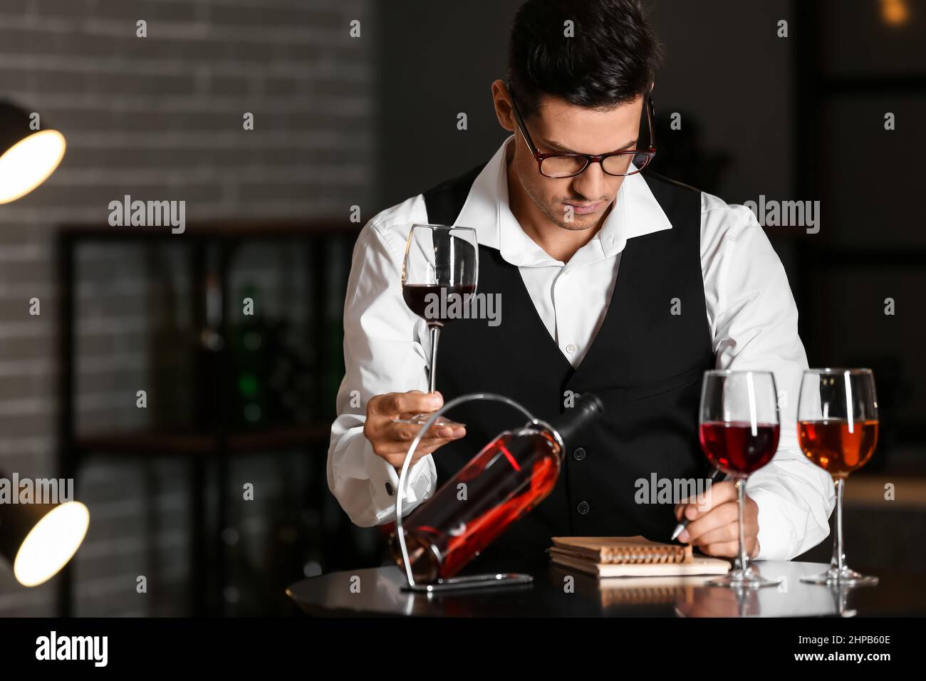 Young male sommelier tasting types of wine Stock Photo - Alamy
