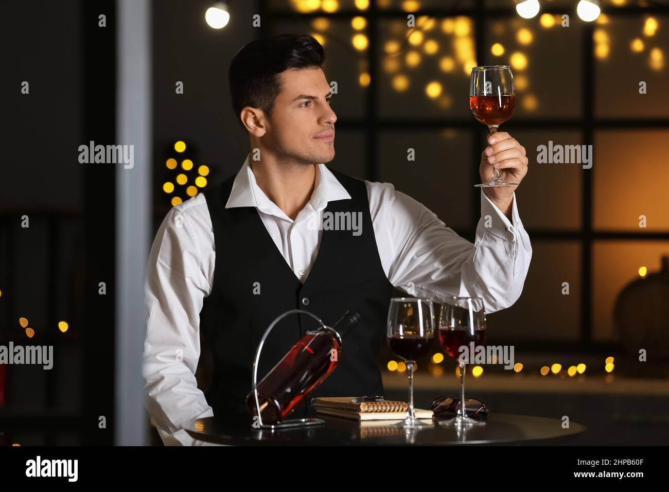 Young male sommelier tasting types of wine Stock Photo - Alamy