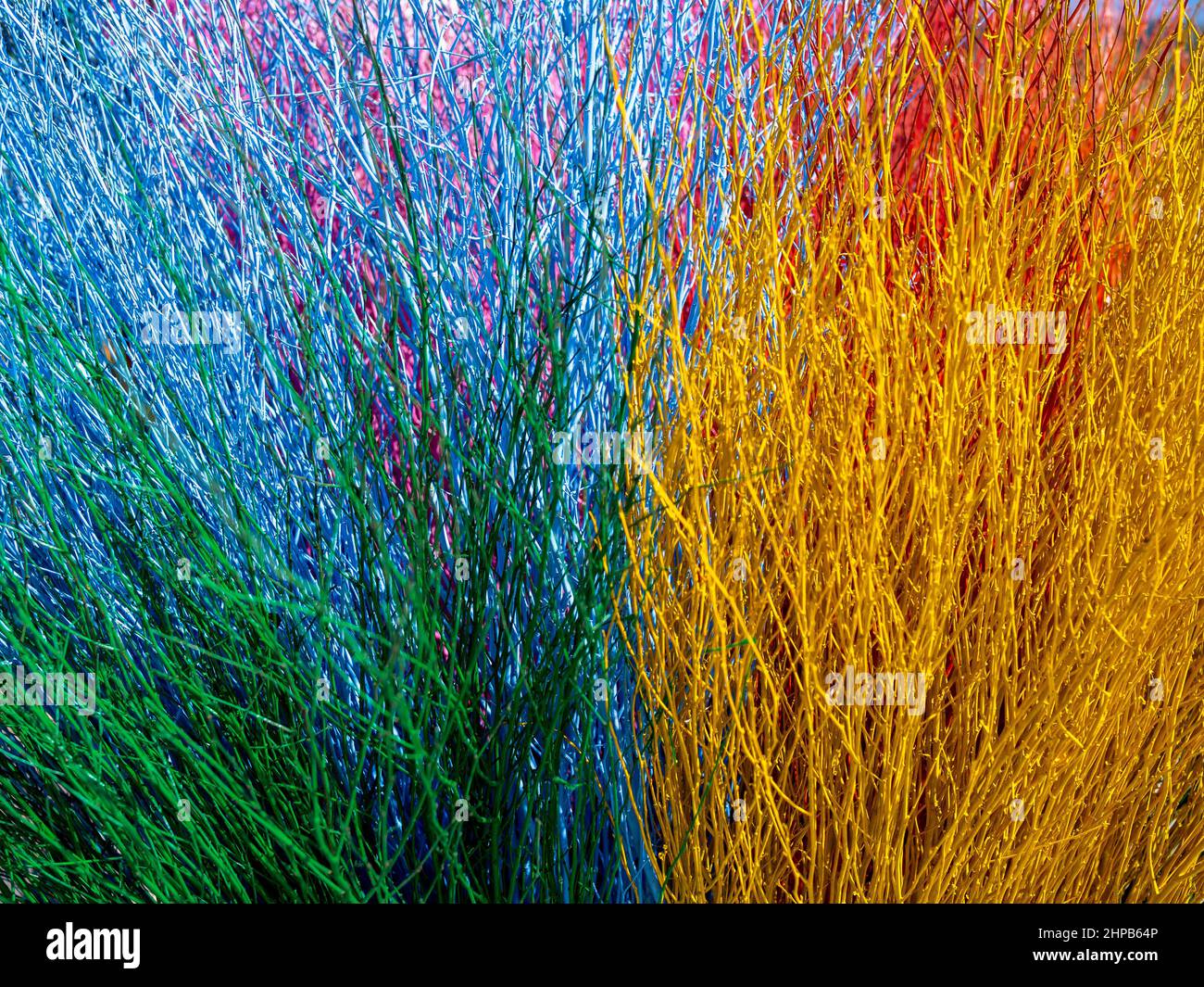 Piles of colorful vintage dried branches background. Blue, yellow ...