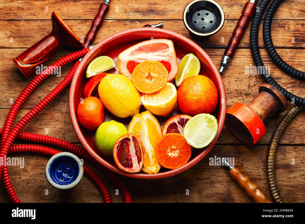 Smoking kalian or shisha with tobacco from citrus fruits. Traditional ...