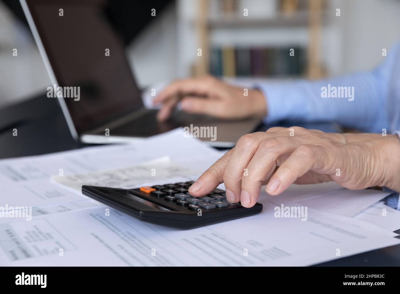 Close up middle aged senior woman calculating utility bills Stock Photo ...