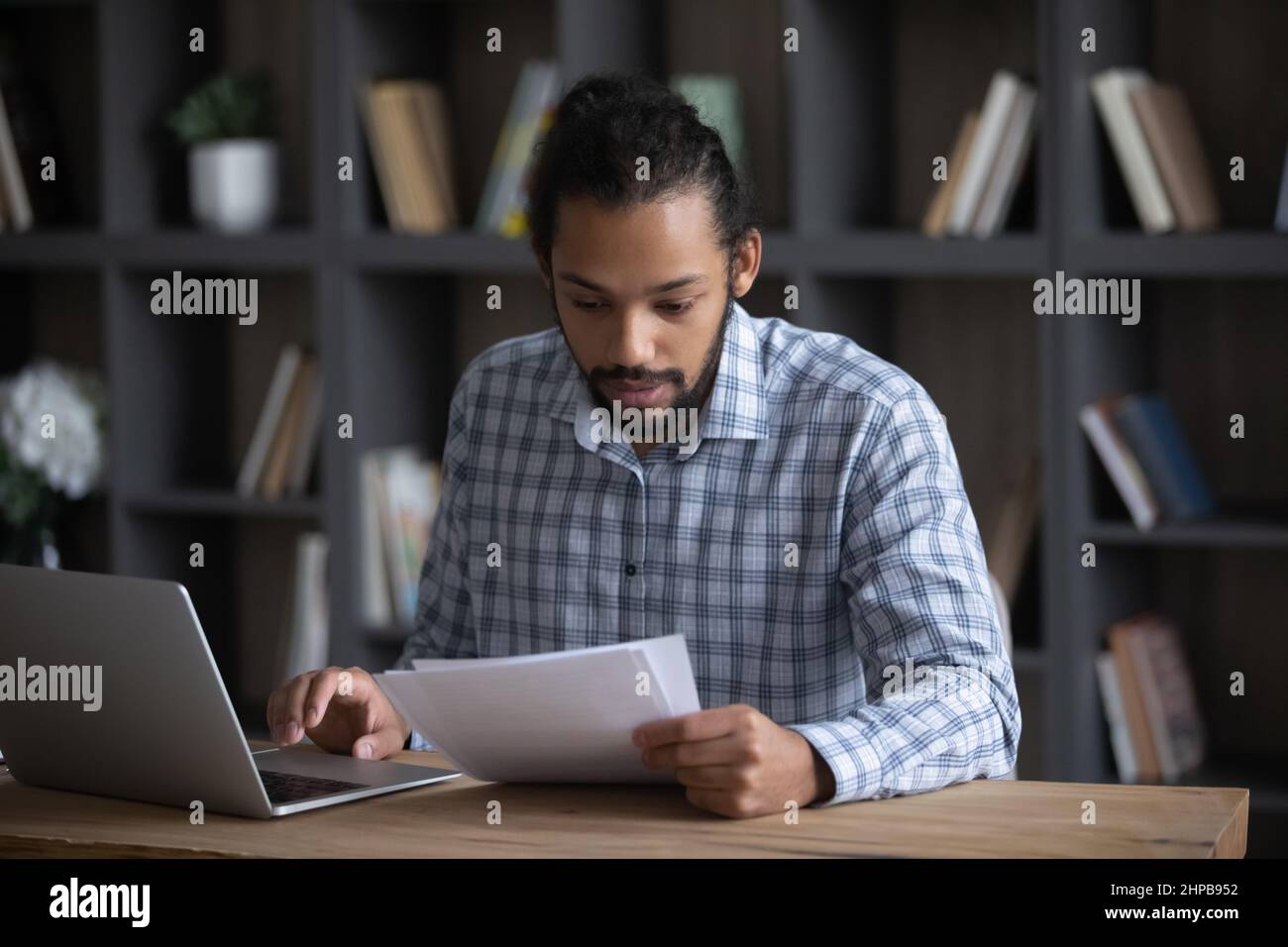 Focused smart 30s millennial African American businessman working with ...