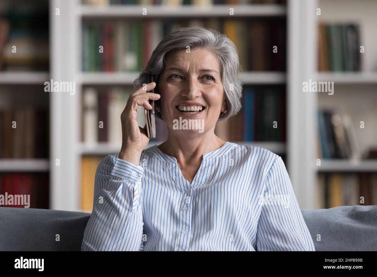 Happy attractive elderly woman holding cellphone call conversation ...