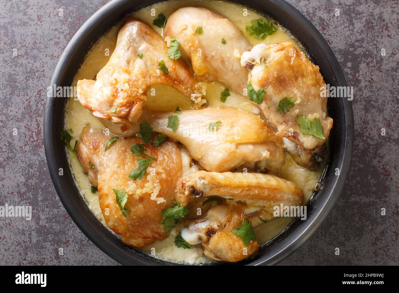 Shkmeruli is a traditional Georgian dish made with fried chicken slowly ...