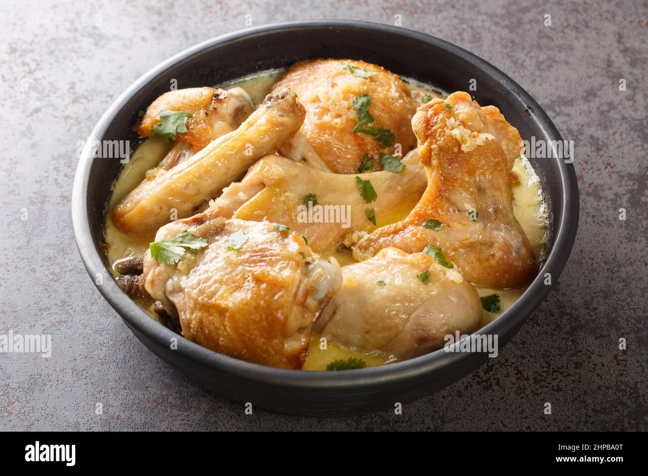 Shkmeruli is a traditional Georgian dish made with fried chicken slowly ...