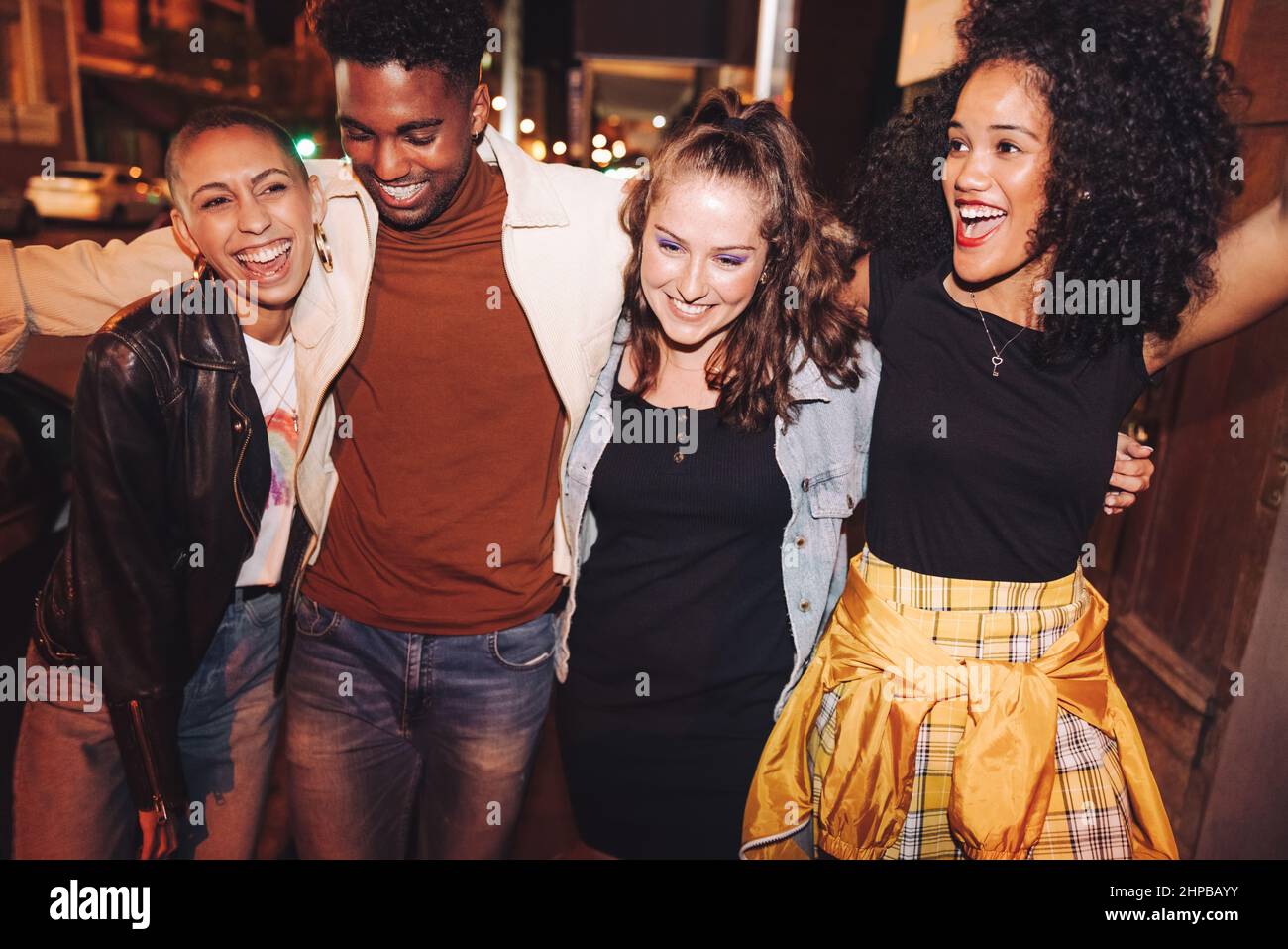 Going out on a Friday night. Group of vibrant young people laughing ...